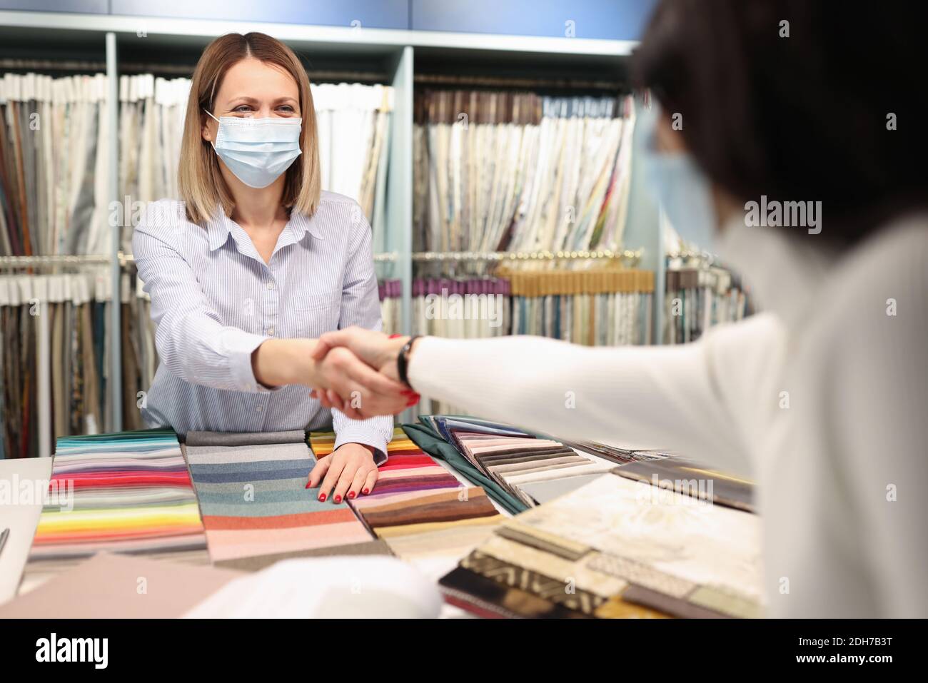 Consultant and customer shake hands in fabric store Stock Photo - Alamy Consultant and customer shake hands in fabric store Stock Photo - Alamy