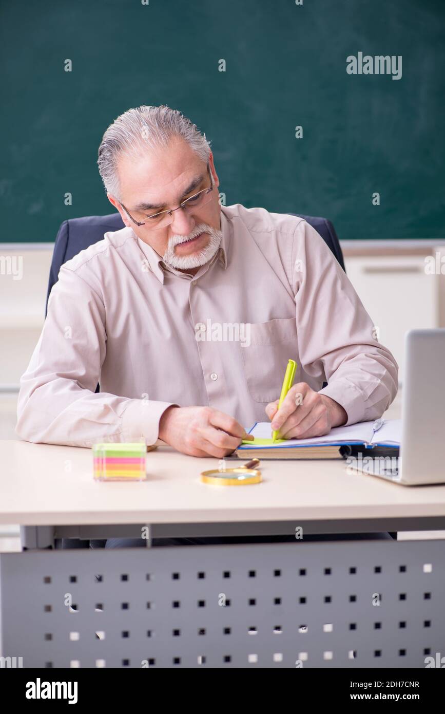 Old male teacher in the classroom Stock Photo - Alamy