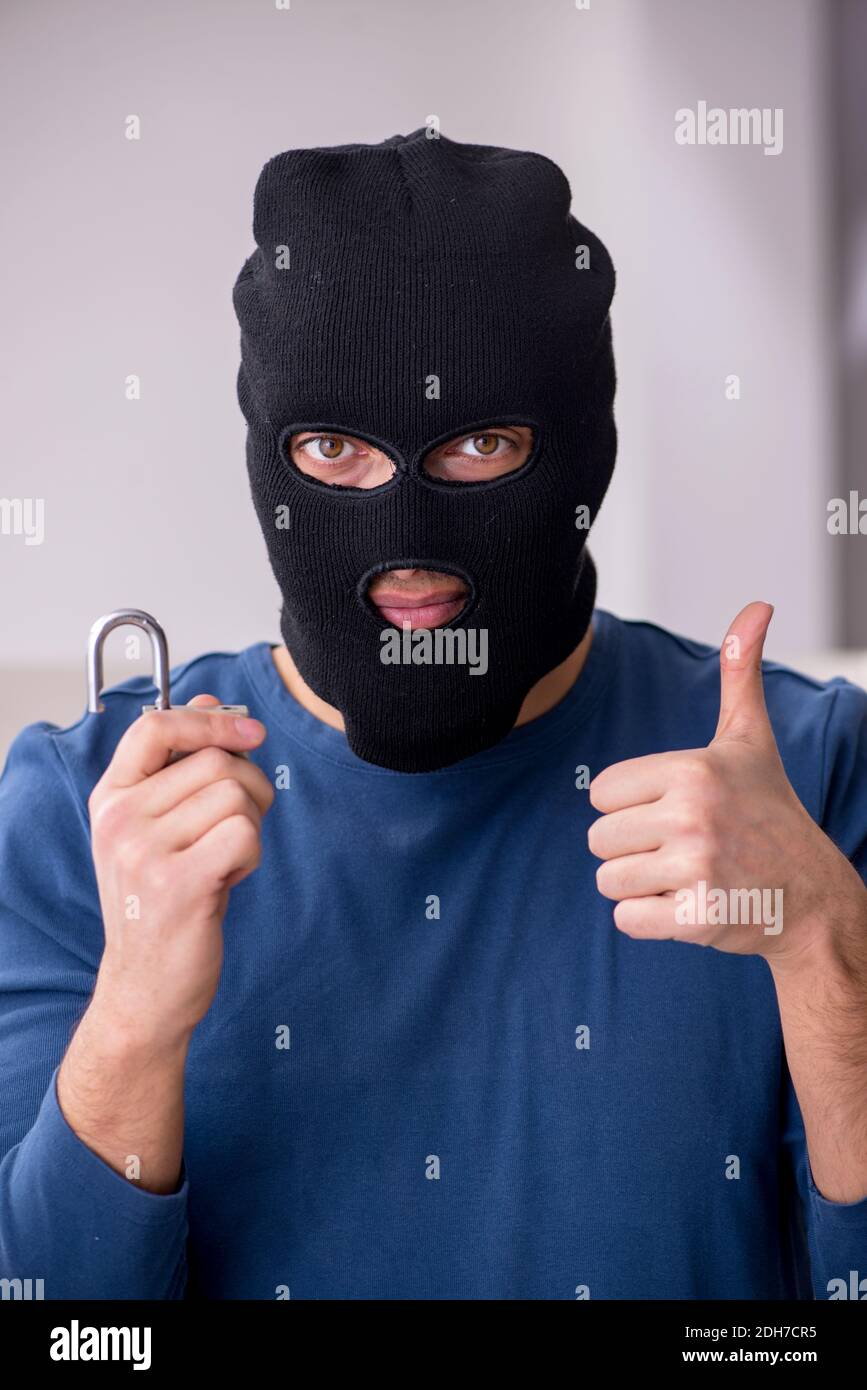 Male robber stealing valuable things from the house Stock Photo - Alamy