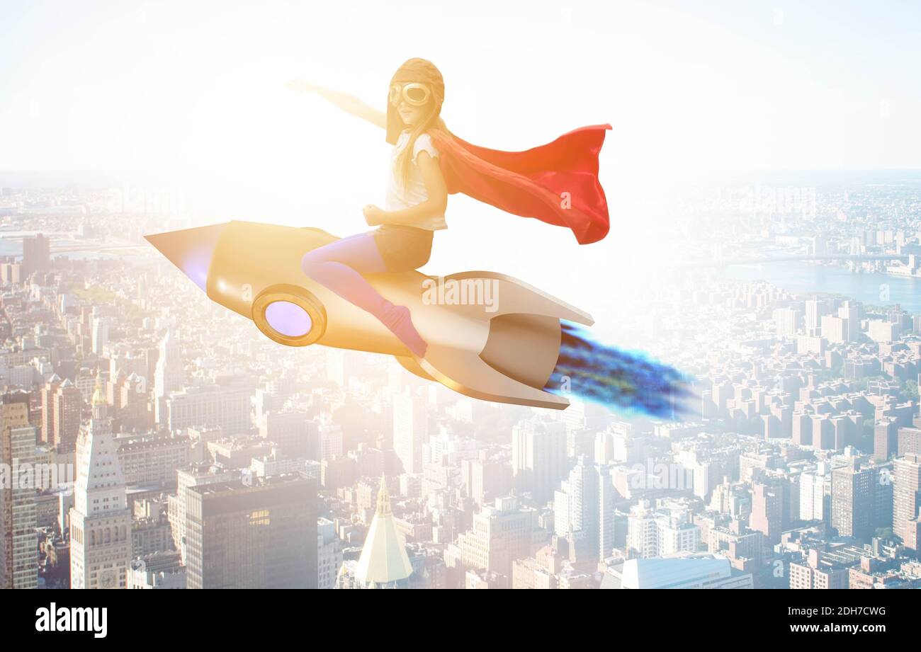 Little girl flying rocket in superhero concept Stock Photo - Alamy