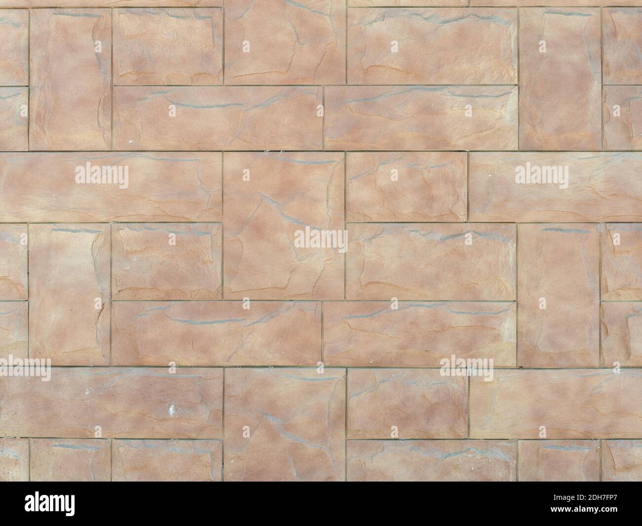 Beige wall with embossed rectangular tiles lined with pattern ...
