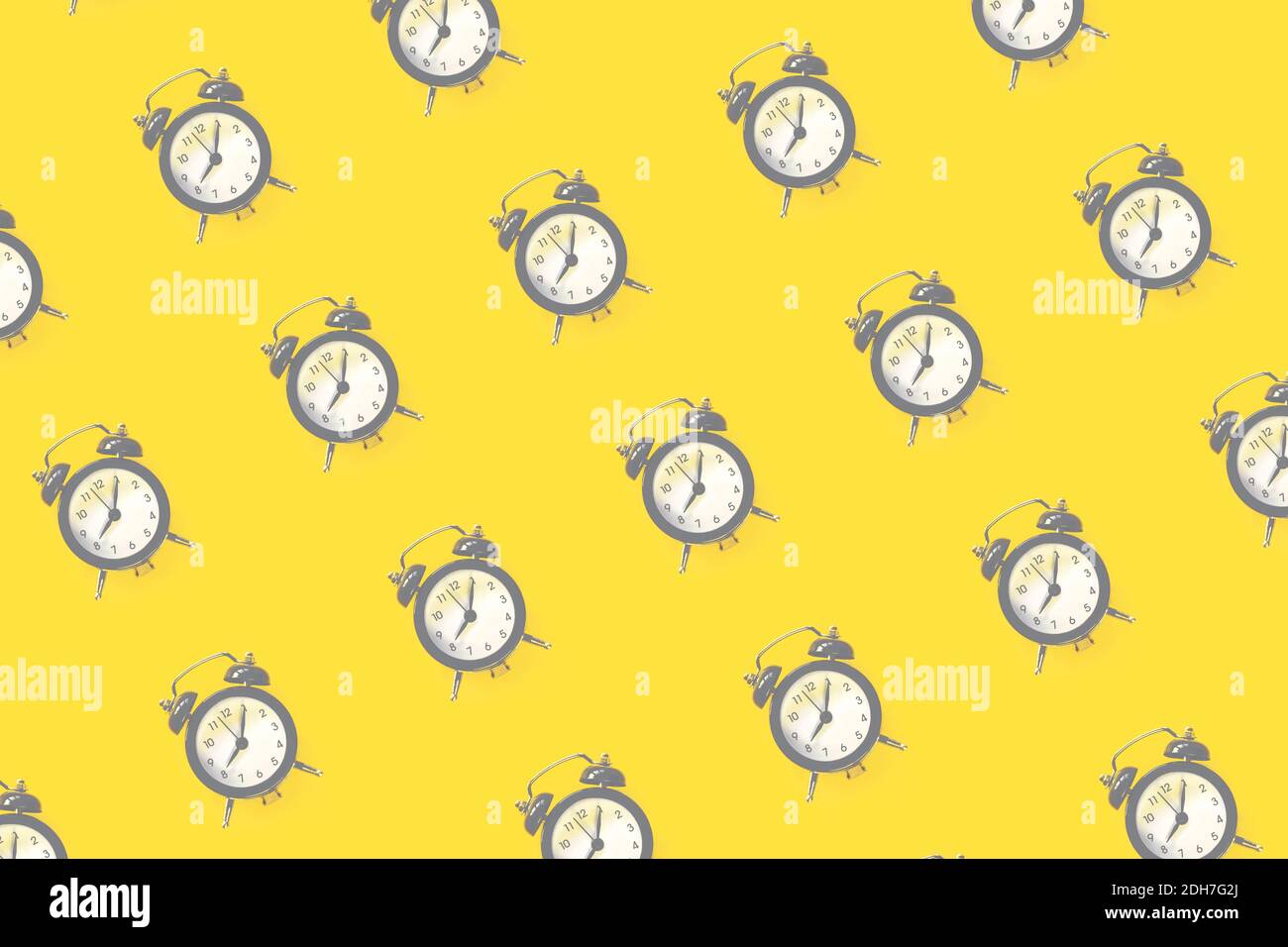 Pattern made of alarm clock on yellow background, top view Stock Photo ...