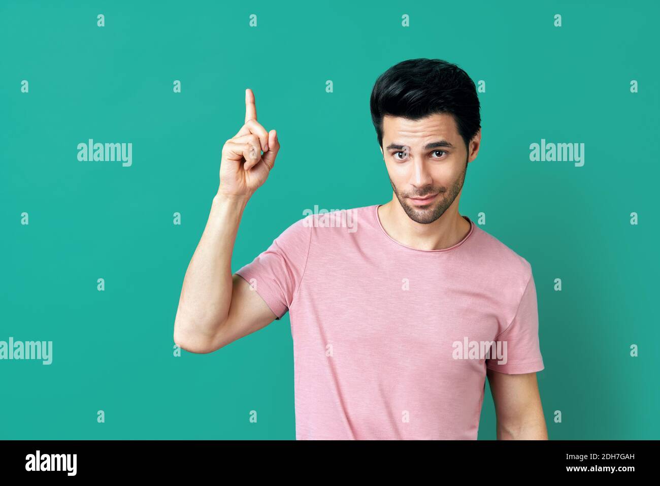 Handsome guy pointing finger up hi-res stock photography and images - Alamy