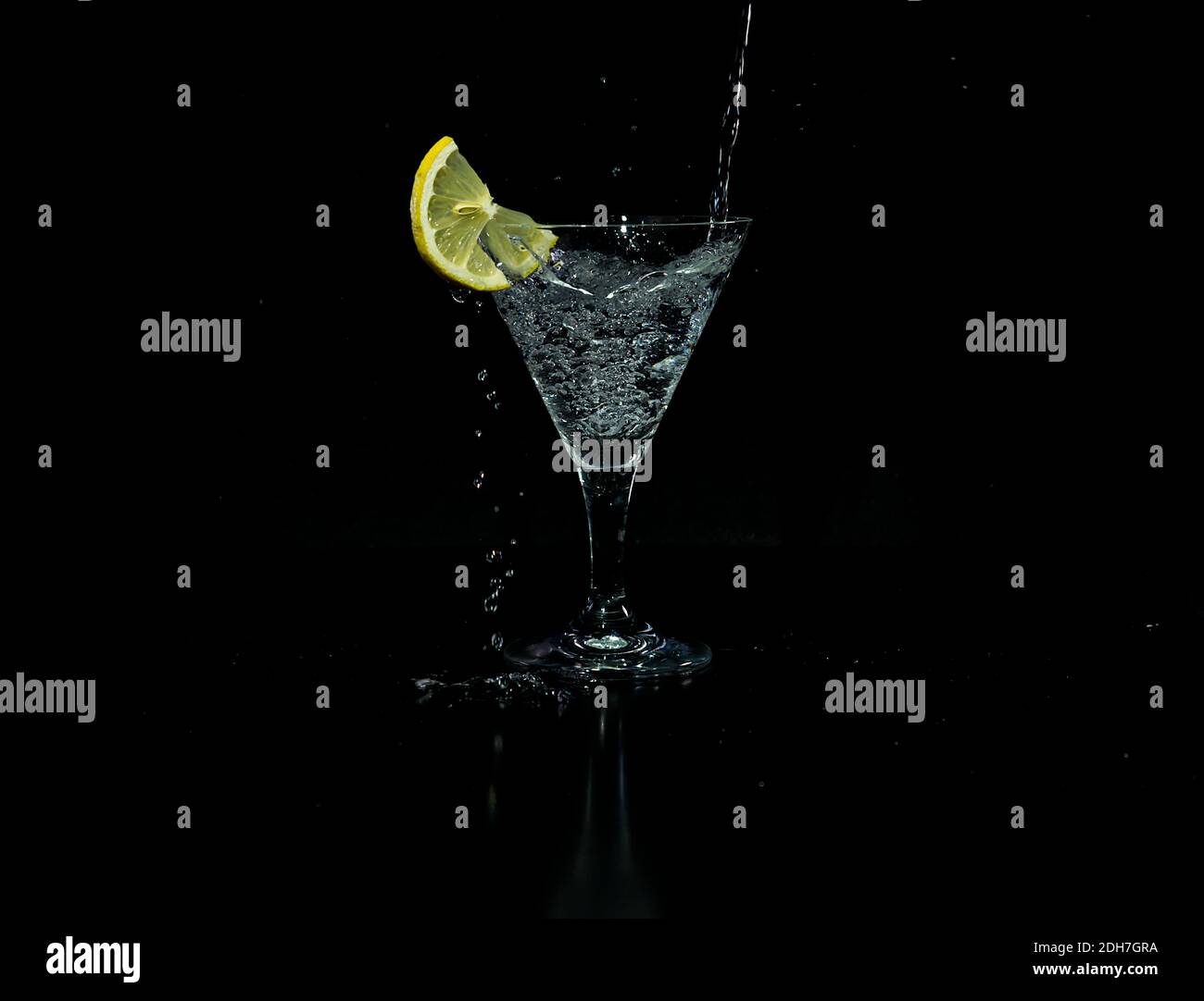 Fill up a martini glass cocktail with citrus fruit Stock Photo - Alamy