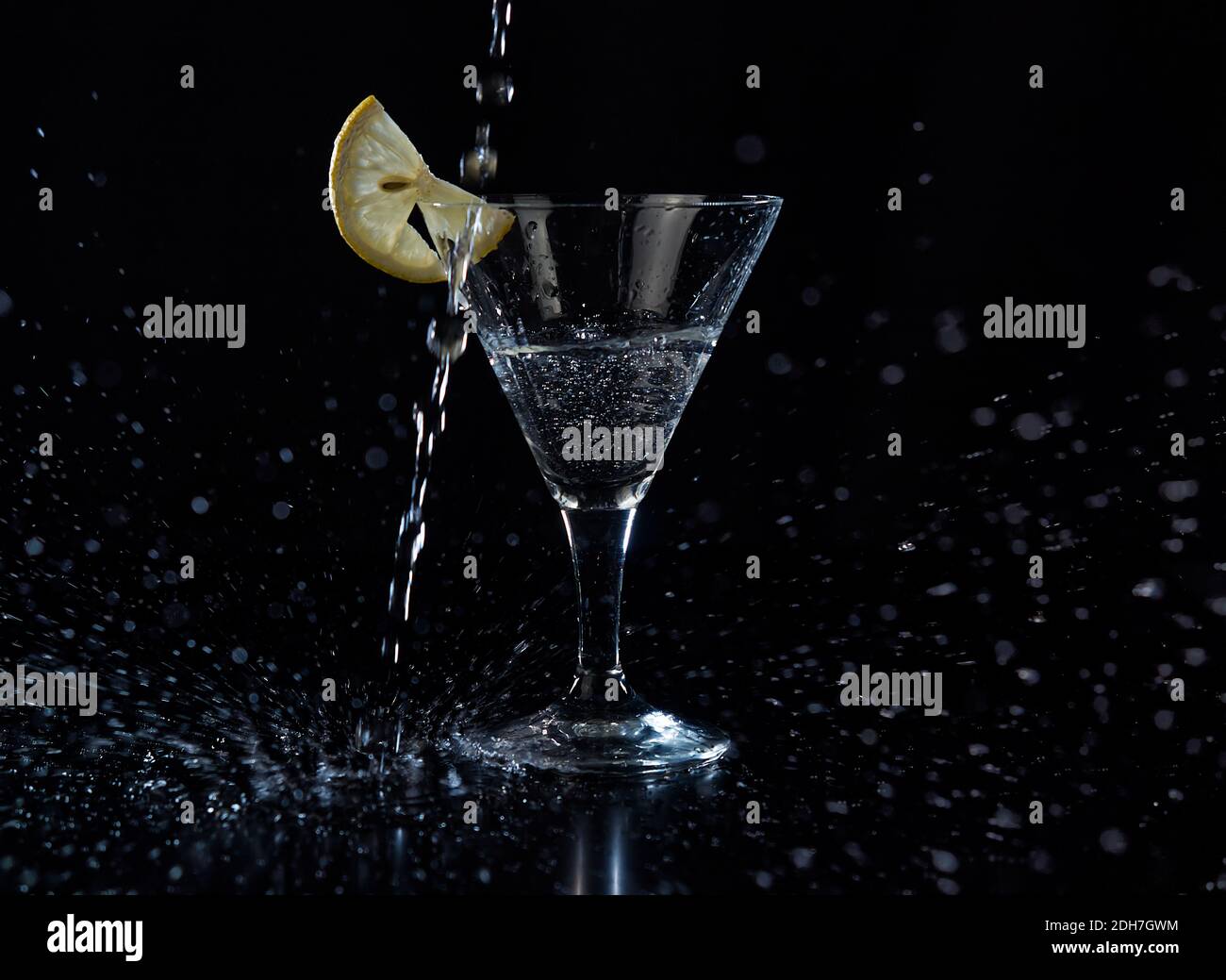 Fill up a martini glass cocktail with citrus fruit Stock Photo - Alamy