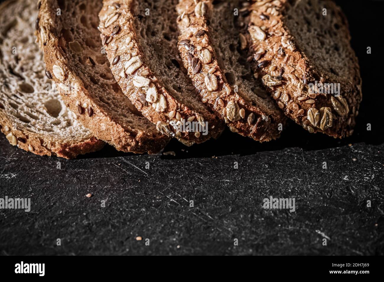 Fresh whole grain seeded bread, organic wheat flour, closeup slice ...