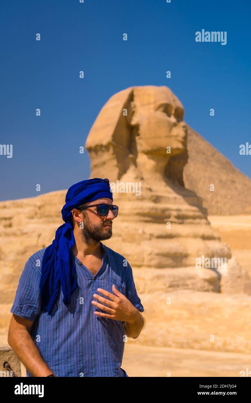 A young tourist wearing a blue turban standing near the Great Sphinx of ...