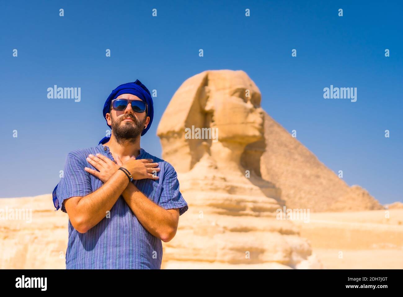 A young tourist wearing a blue turban standing near the Great Sphinx of ...