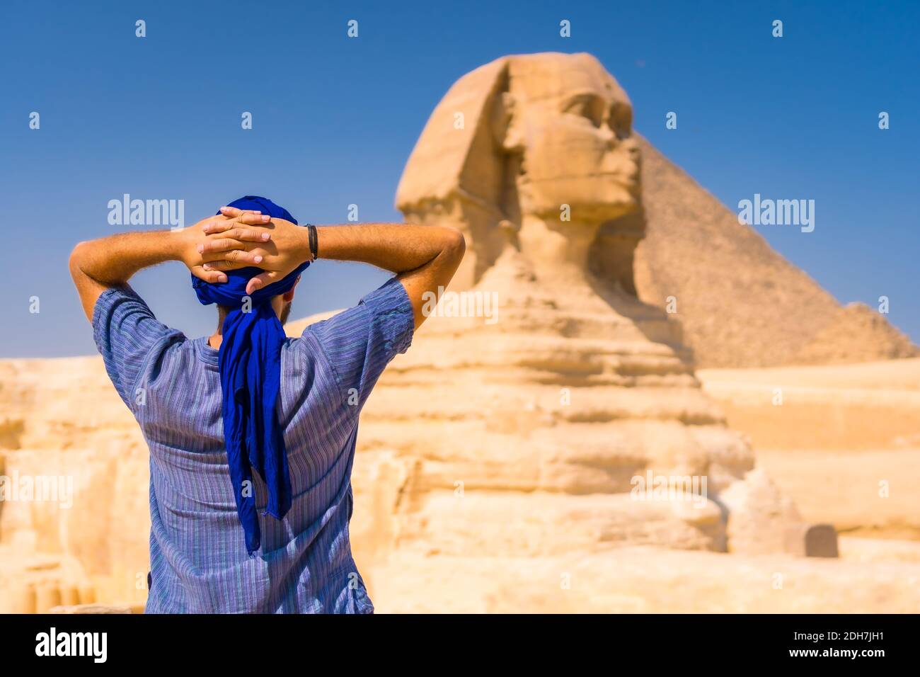 A young tourist wearing a blue turban standing near the Great Sphinx of ...