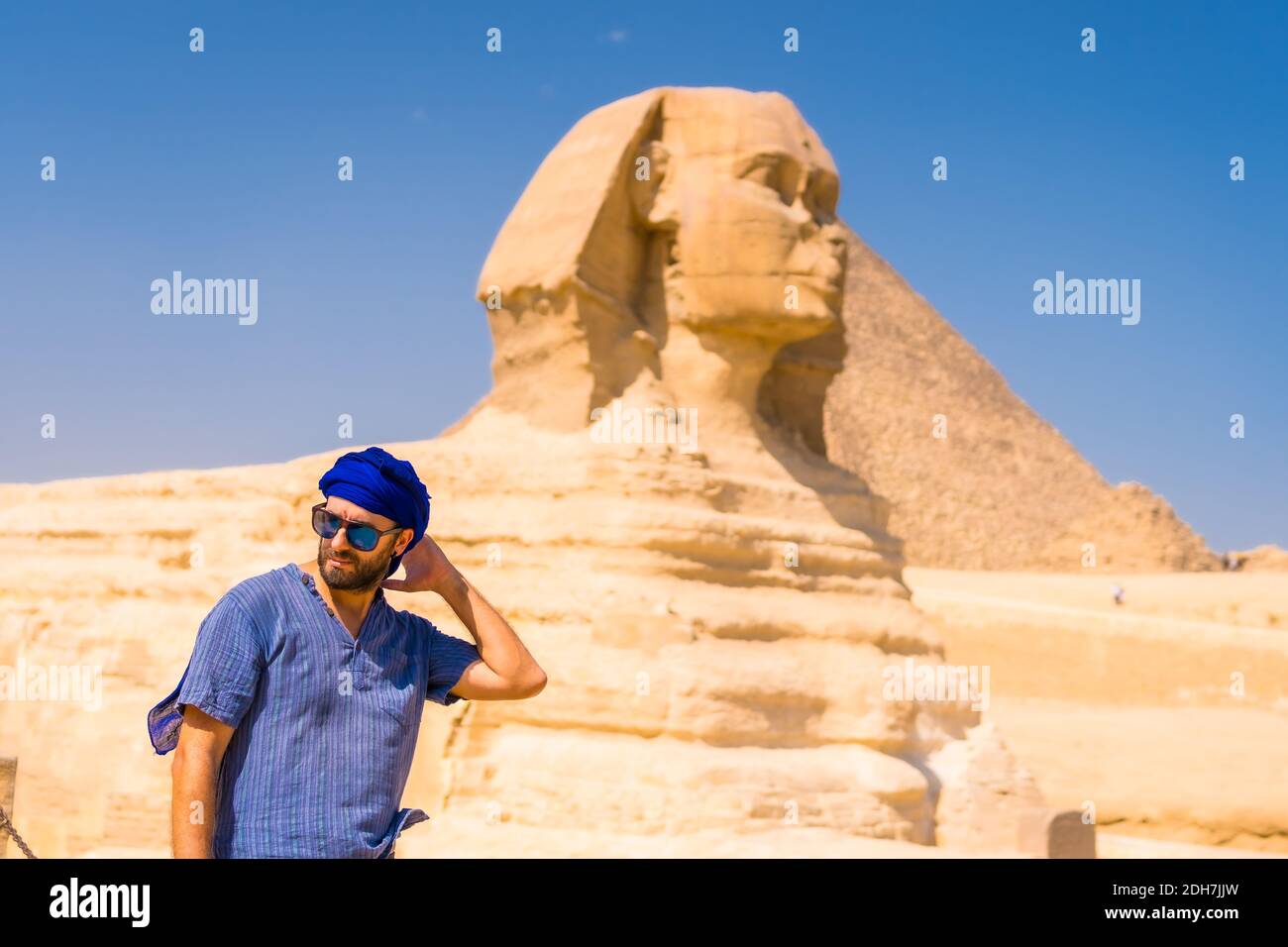 A young tourist wearing a blue turban standing at the Great Sphinx of ...