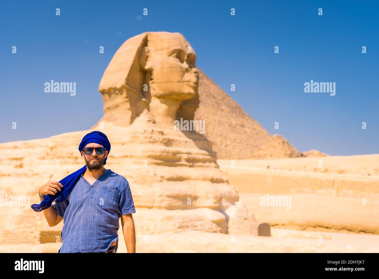 A young tourist wearing a blue turban standing at the Great Sphinx of ...