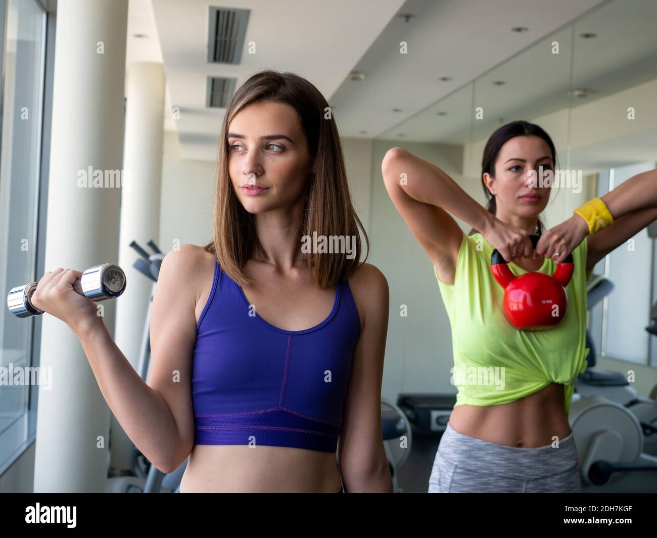 Happy beautiful women working out in gym together Stock Photo - Alamy