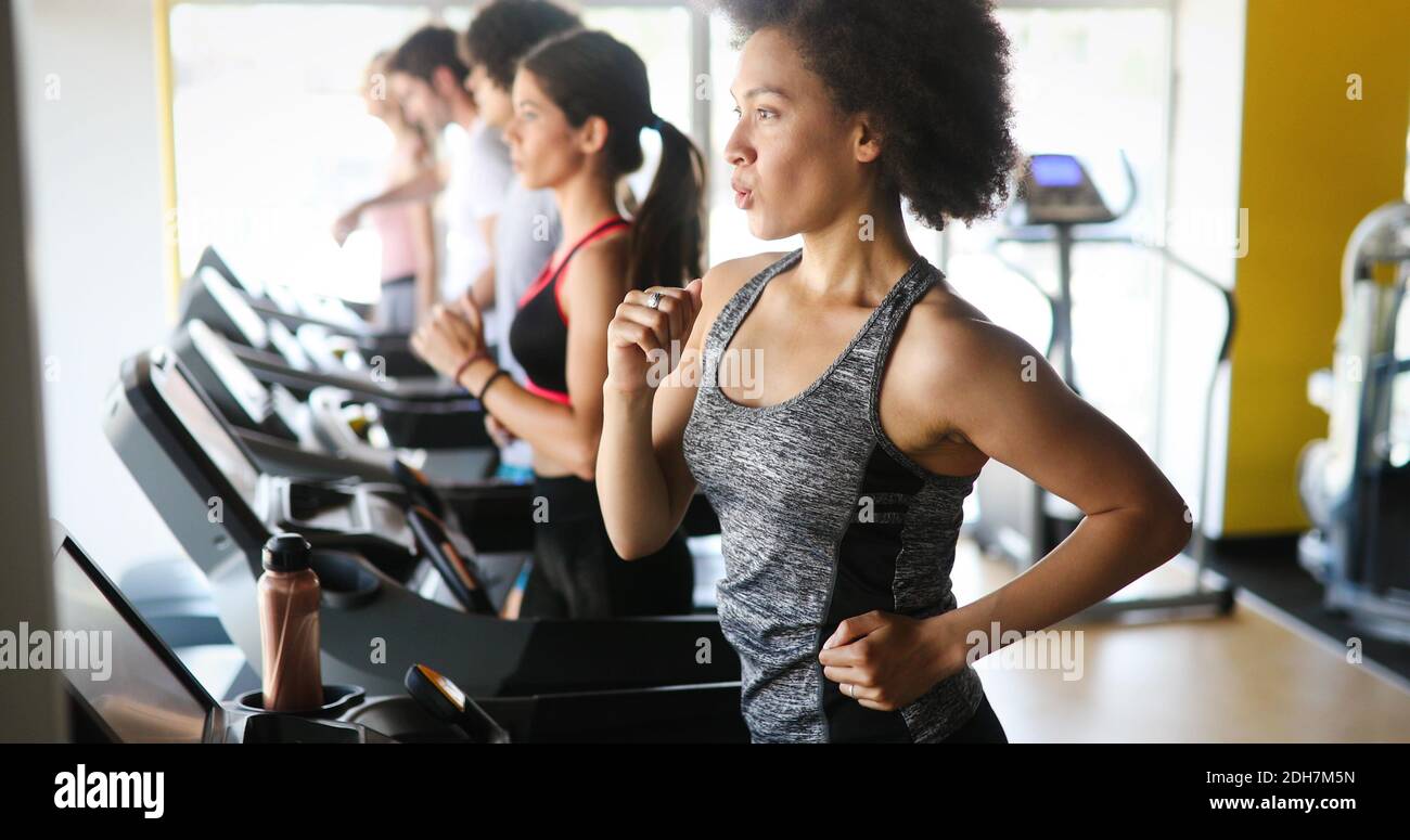 Group of fit healthy friends people cardio workout in gym Stock Photo ...