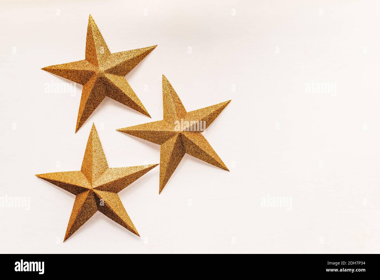 Three golden stars on white background Stock Photo - Alamy