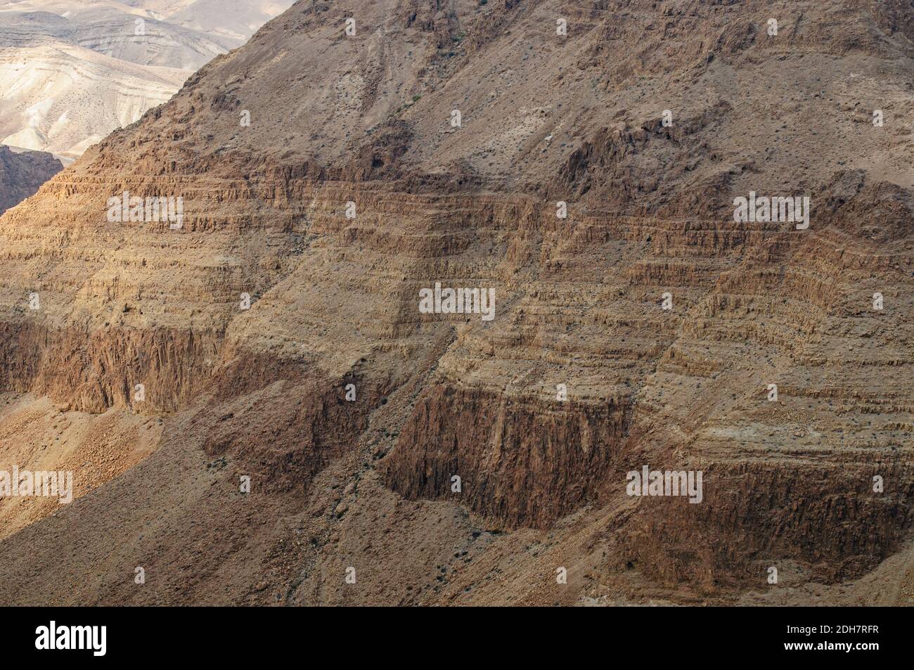 Geological layers are visible on the eroded mountain cliff ...