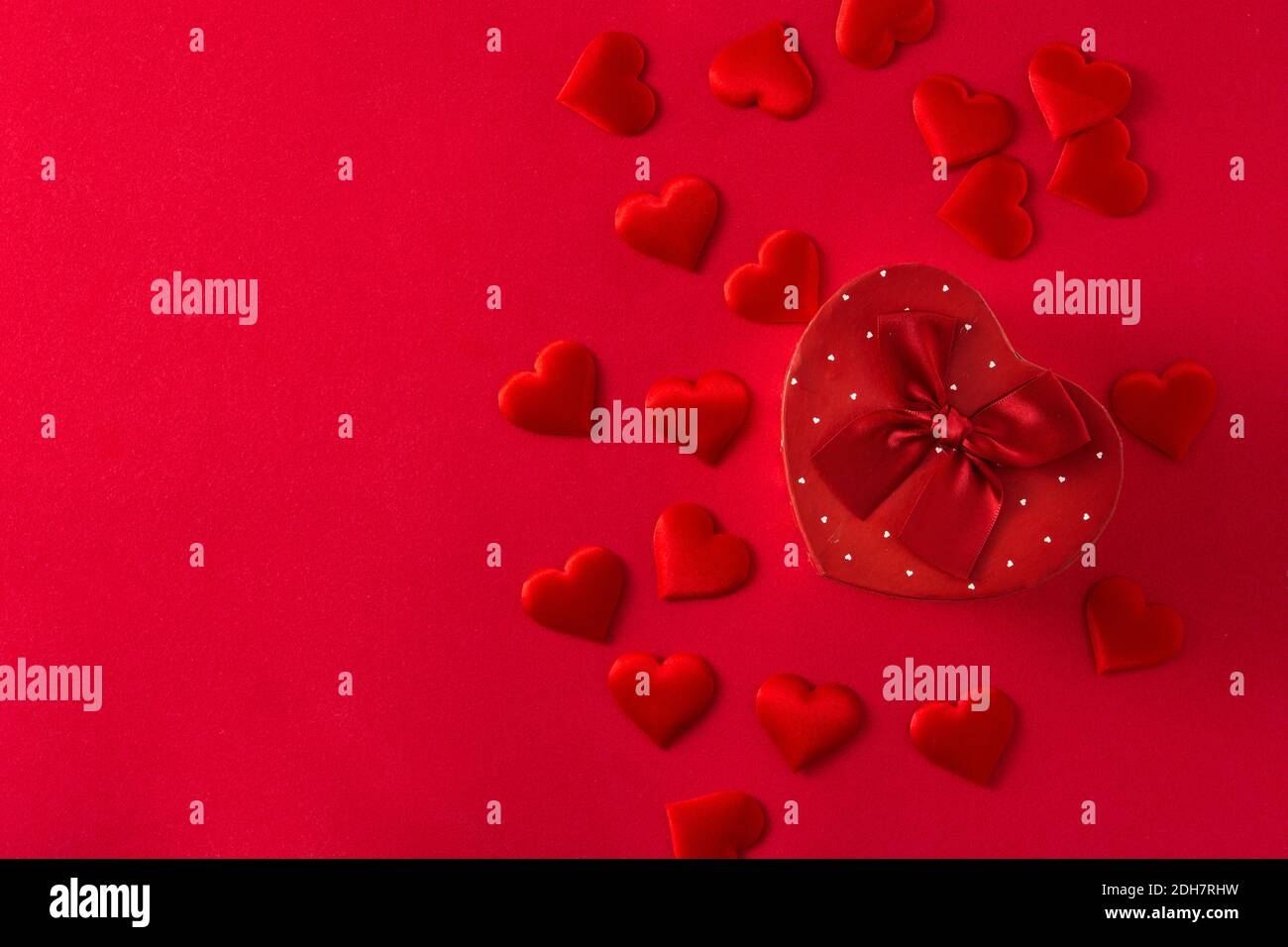 Gift box with heart shape and hearts on red background Stock Photo - Alamy