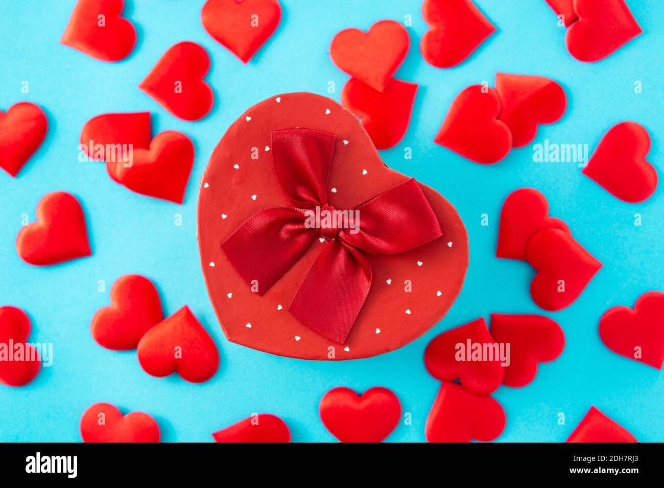 Gift box with heart shape and hearts on blue background Stock Photo - Alamy