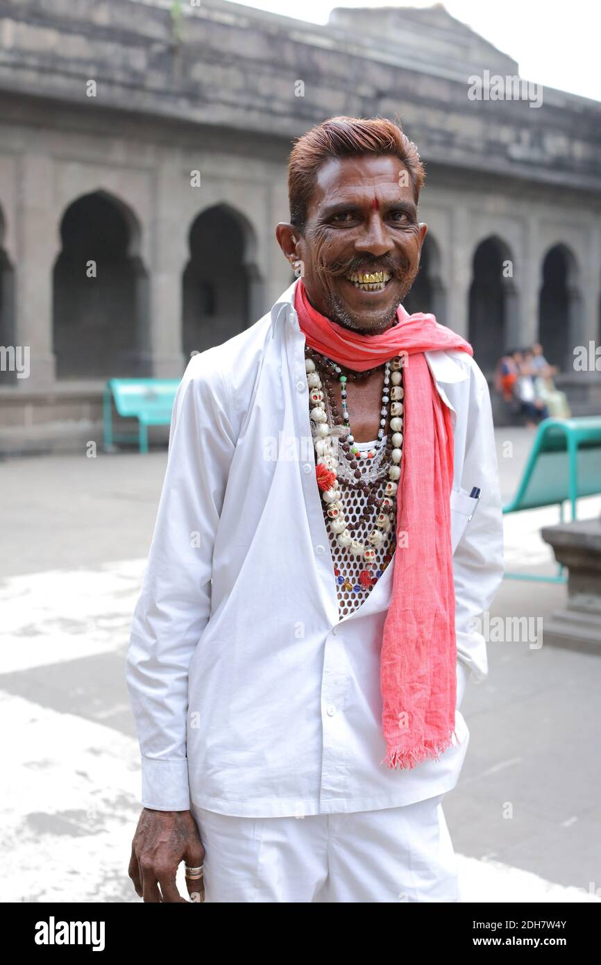 Indian man with metal golden teeth at ancient Hindu temple Kalaram in ...