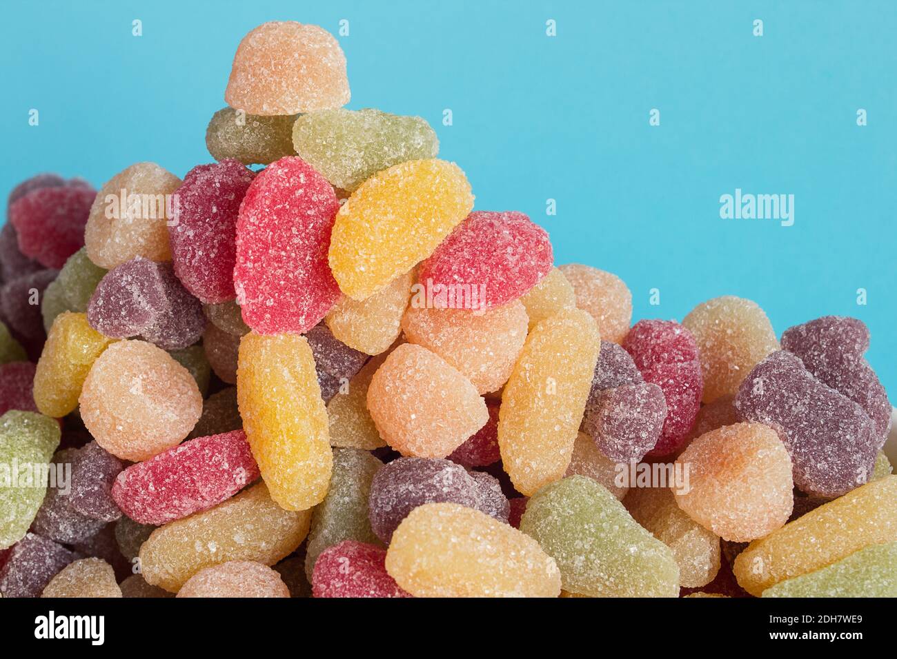 A mountain of colored sugary candies with a blue sky background Stock ...