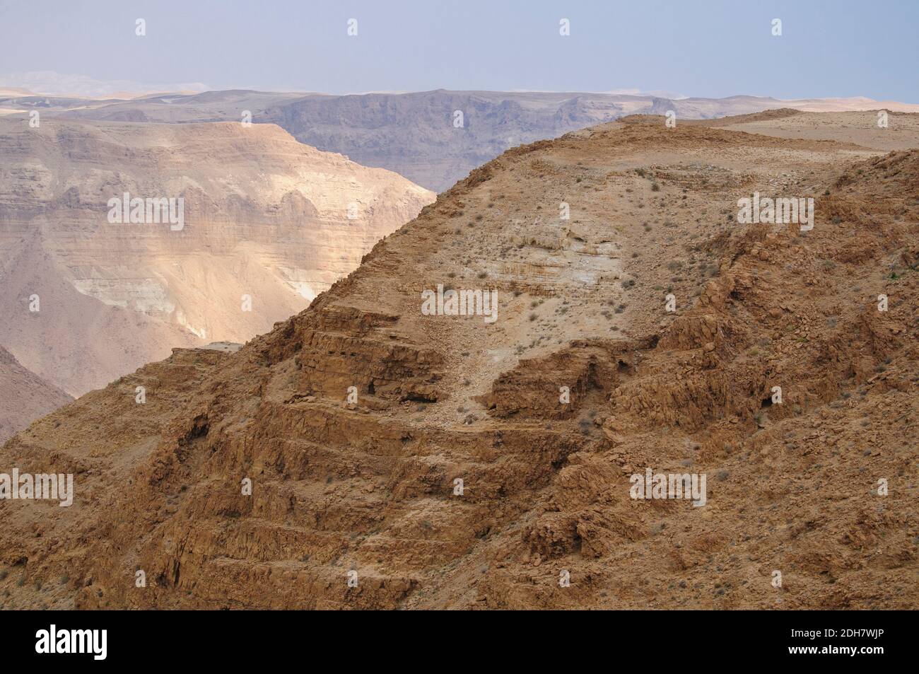 Geological layers are visible on the eroded mountain cliff ...