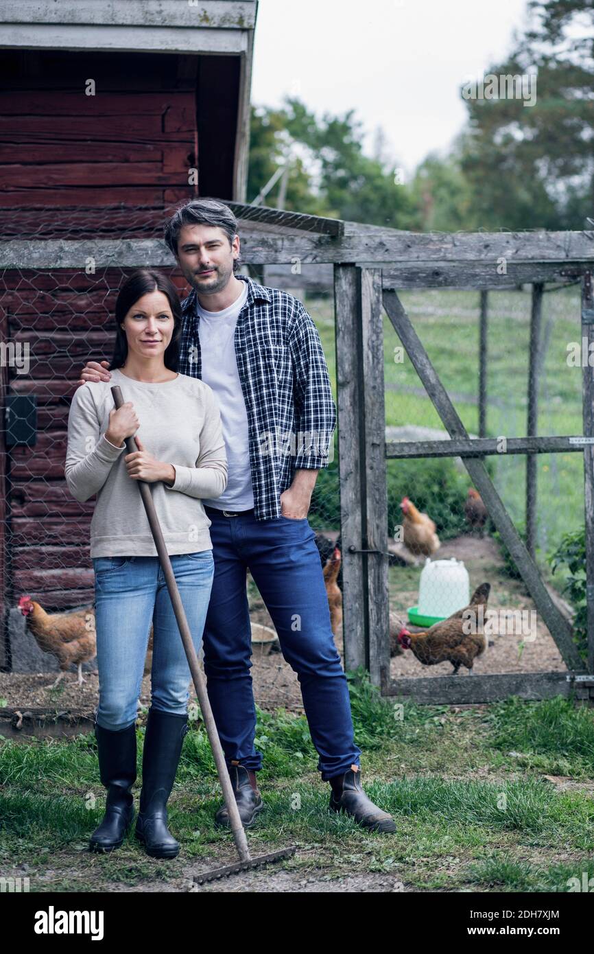 Portrait of couple standing at poultry farm Stock Photo - Alamy