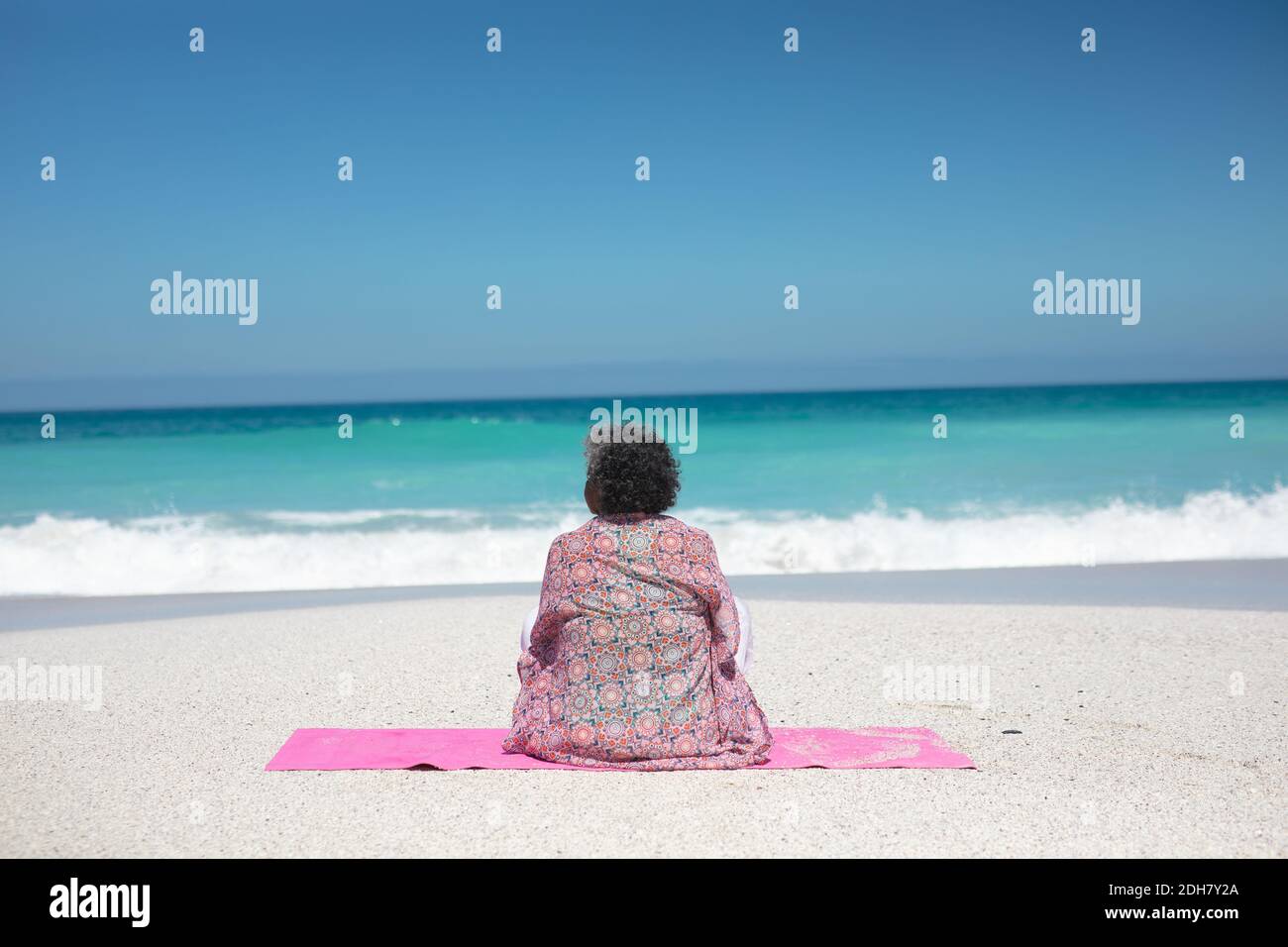 Old woman looking at the waves Stock Photo - Alamy