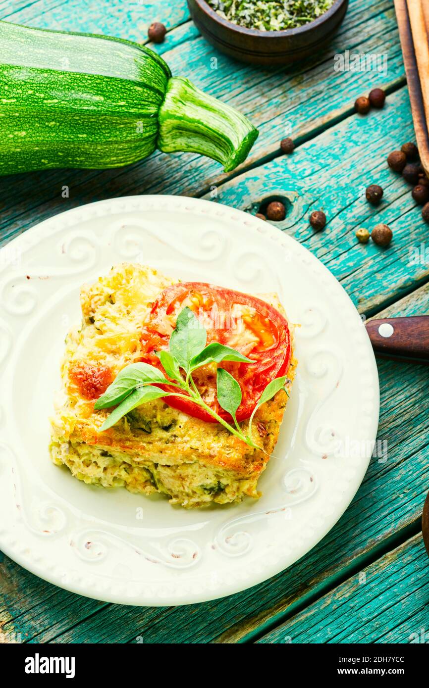Delicious zucchini and tomato omelet on plate.Summer snack Stock Photo ...