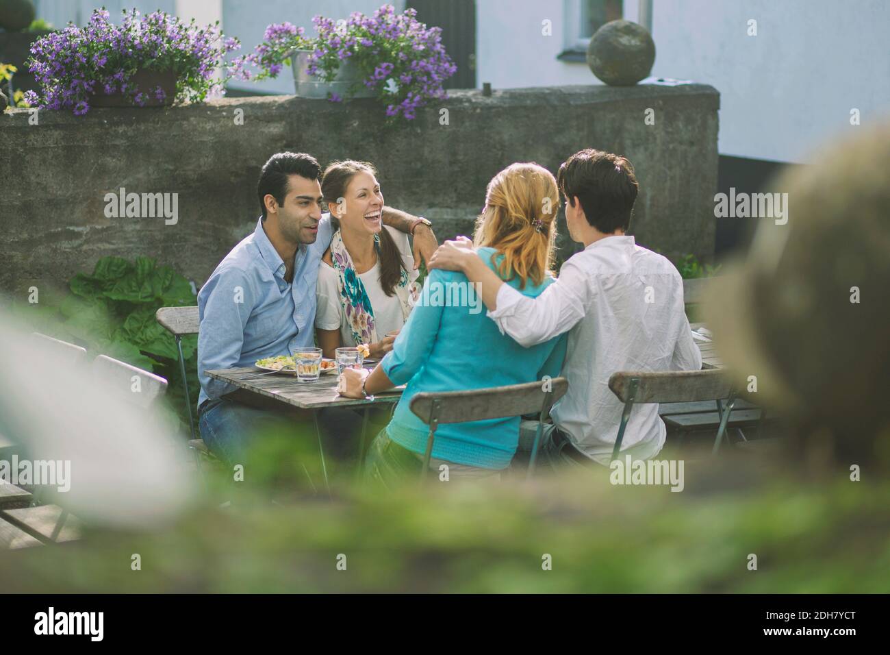 Smiling couples having lunch at outdoor cafe Stock Photo - Alamy