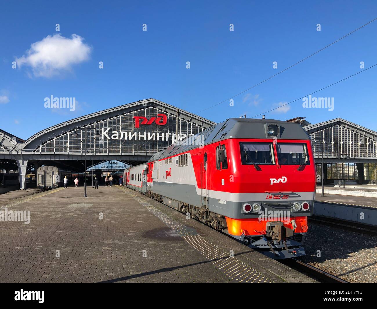 Modern train on platform of railway station Stock Photo - Alamy