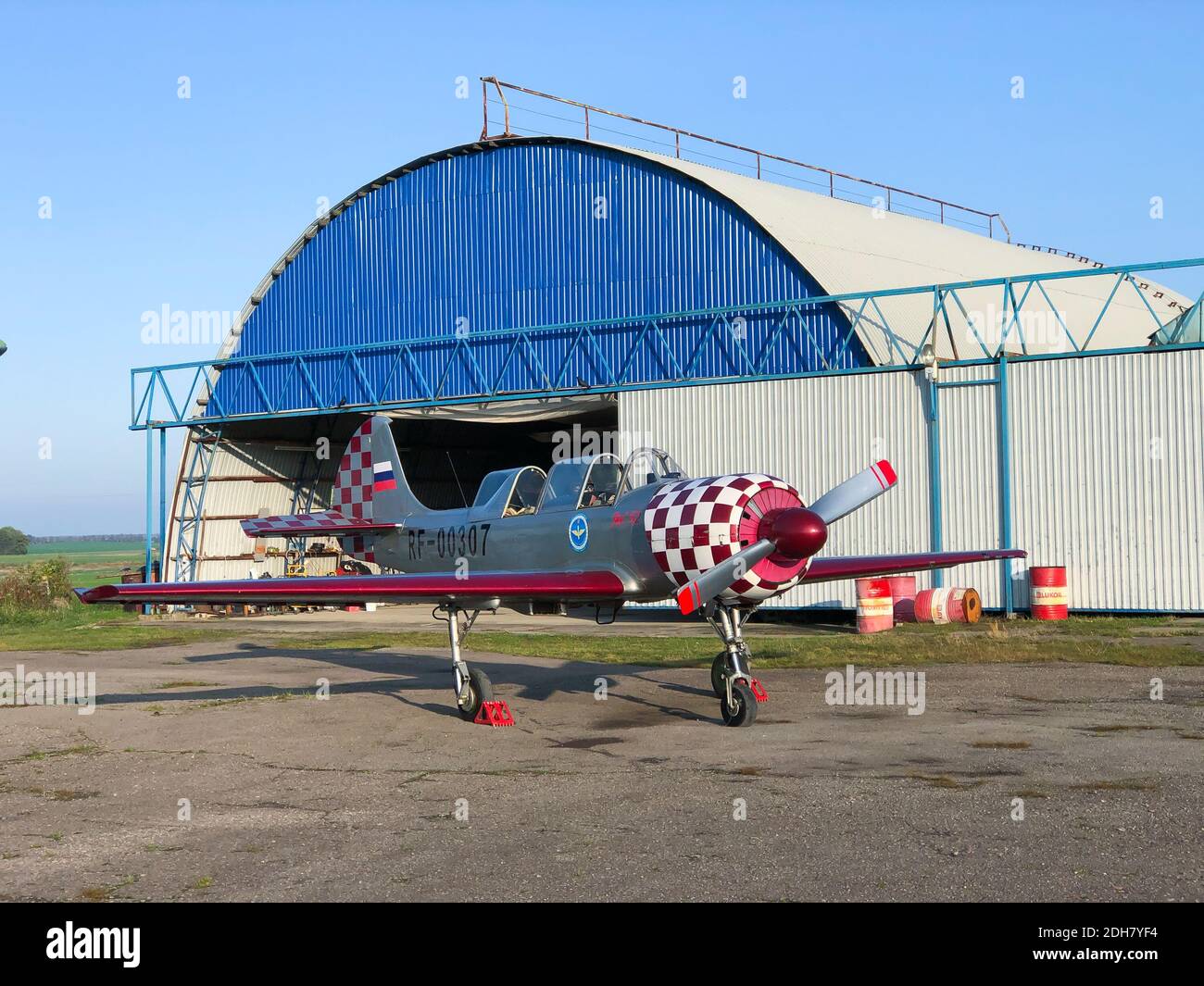 Small modern airplane near hangar Stock Photo - Alamy