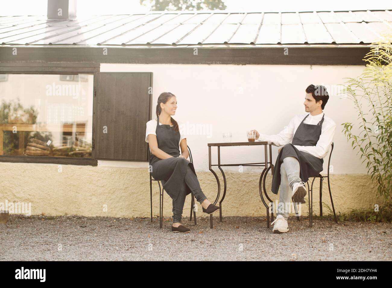 Waitress and waiter taking coffee break outside restaurant Stock Photo ...