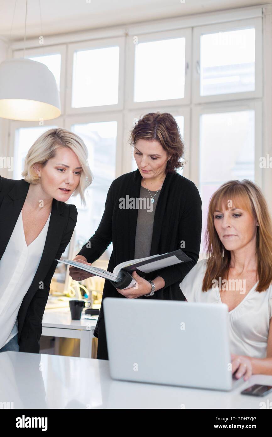 Working at laptop in office hi-res stock photography and images - Alamy
