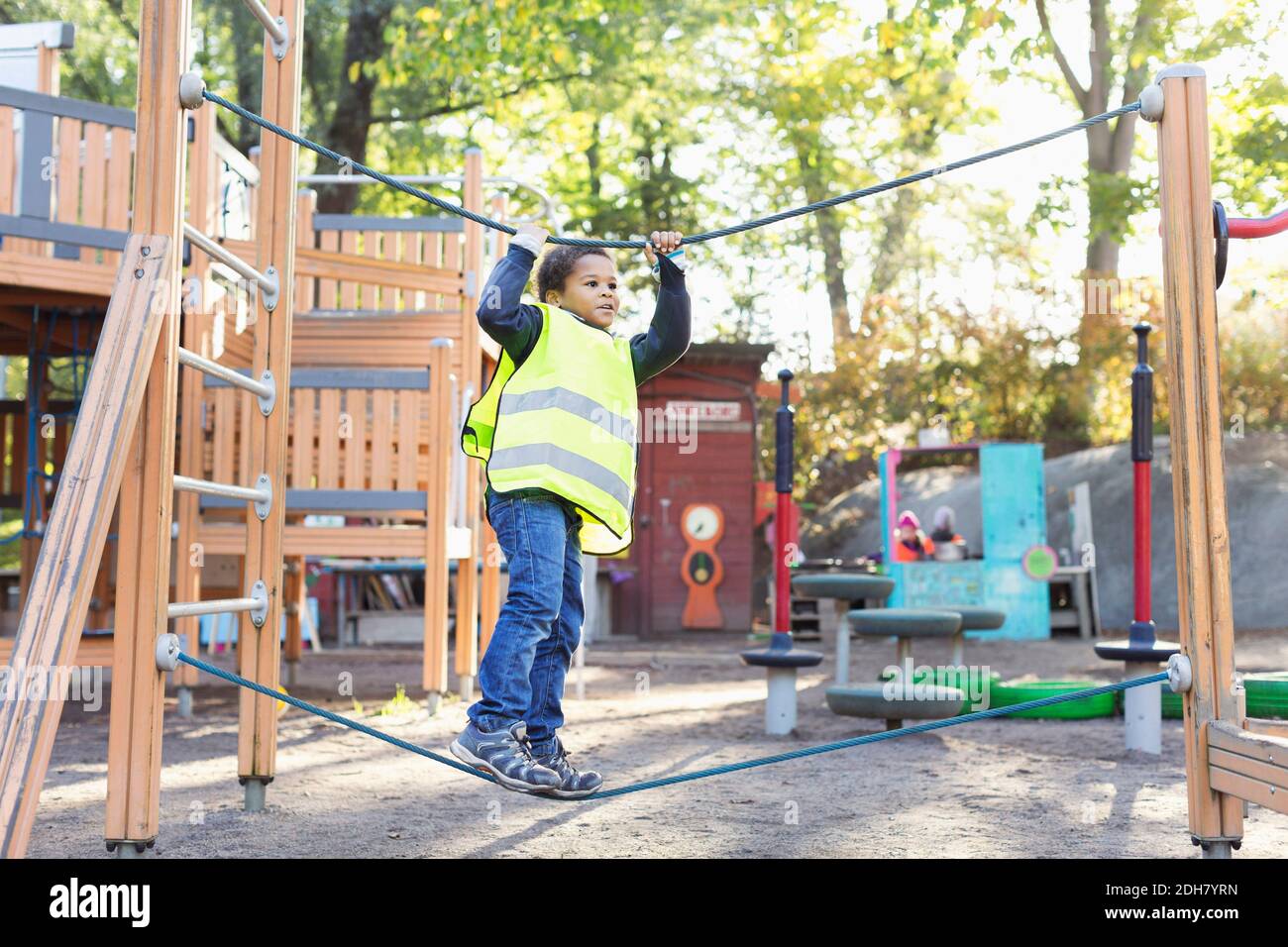 Boy balancing on rope at playground Stock Photo - Alamy