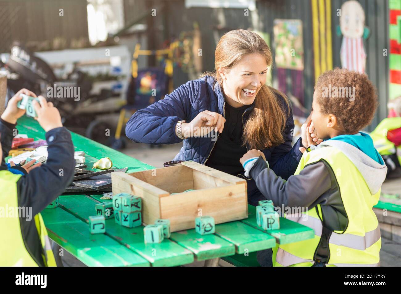 Ethnic preschool teacher at table hi-res stock photography and images ...