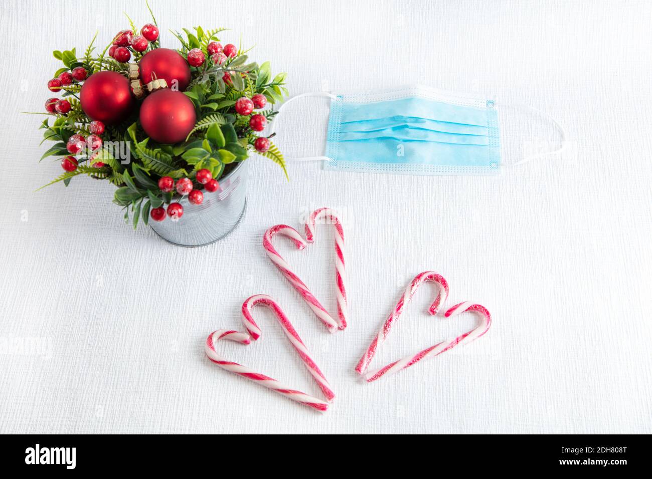 lollipops and medical masks, Christmas accessories on a white ...