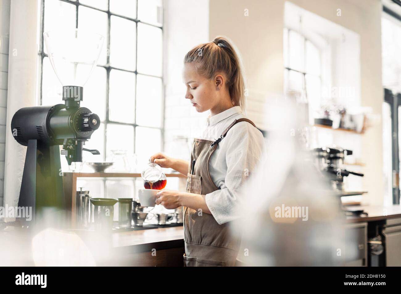 Barista making coffee at cafe counter Stock Photo - Alamy