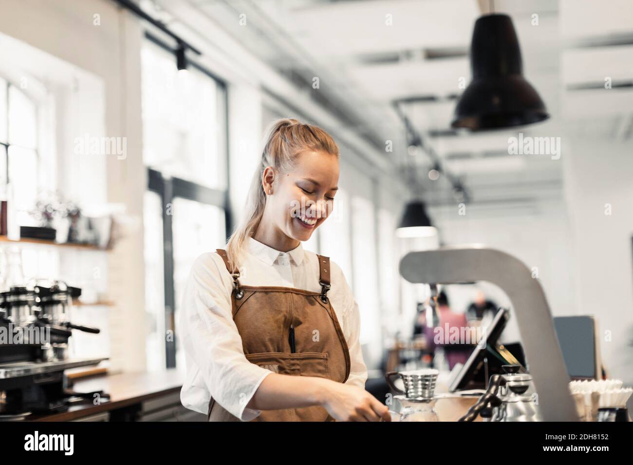 Happy female barista preparing coffee at cafe Stock Photo - Alamy