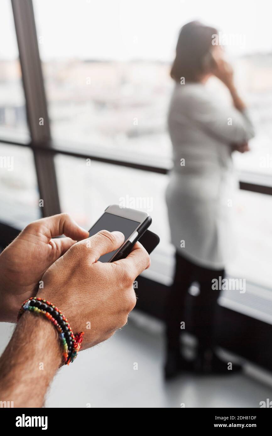 Business people using mobile phones in office Stock Photo - Alamy