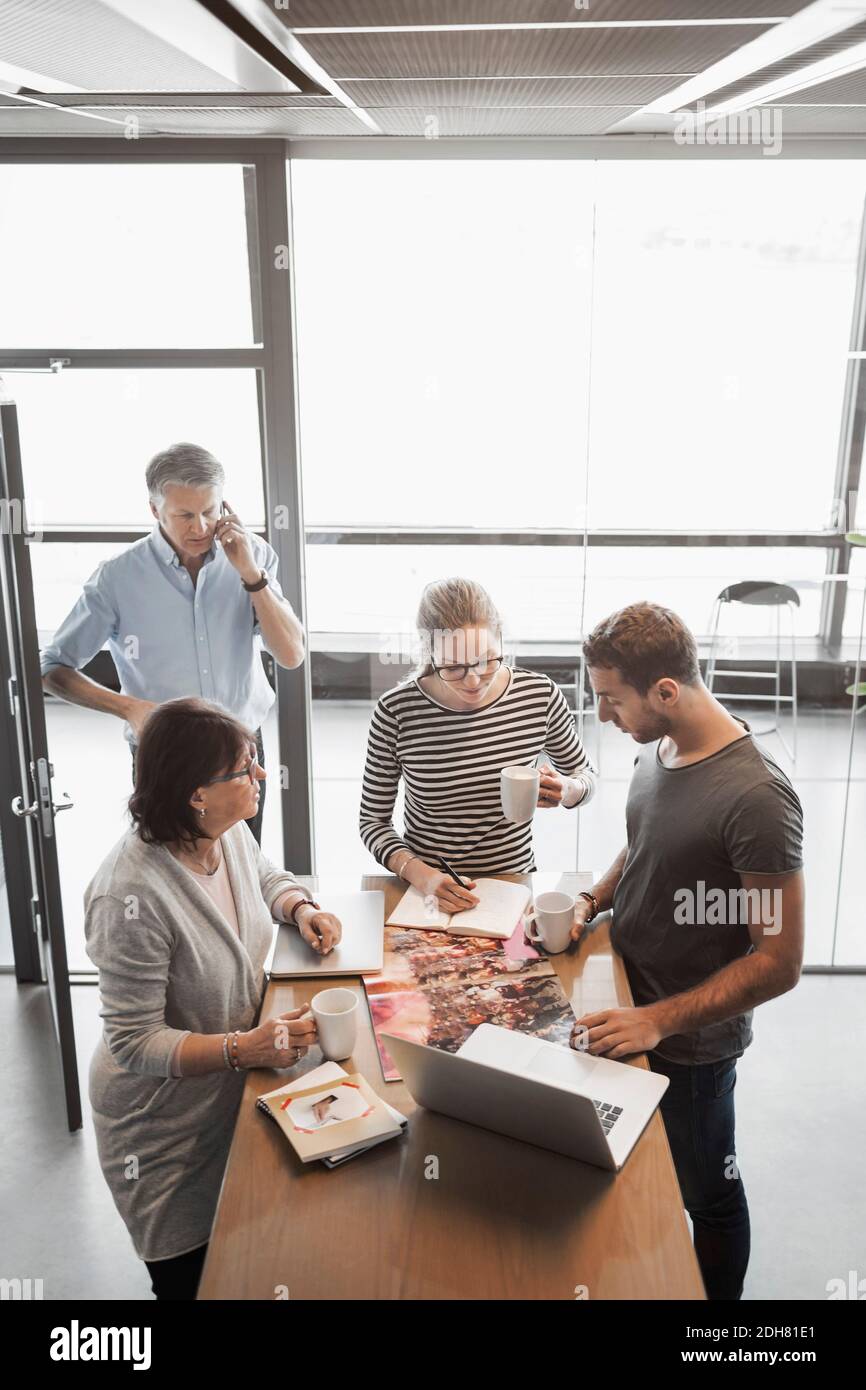 Business people working at counter in office cafe Stock Photo - Alamy