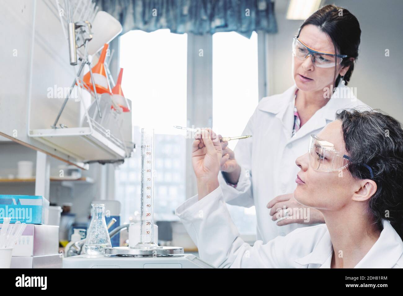 Female scientists analyzing chemical in laboratory Stock Photo - Alamy