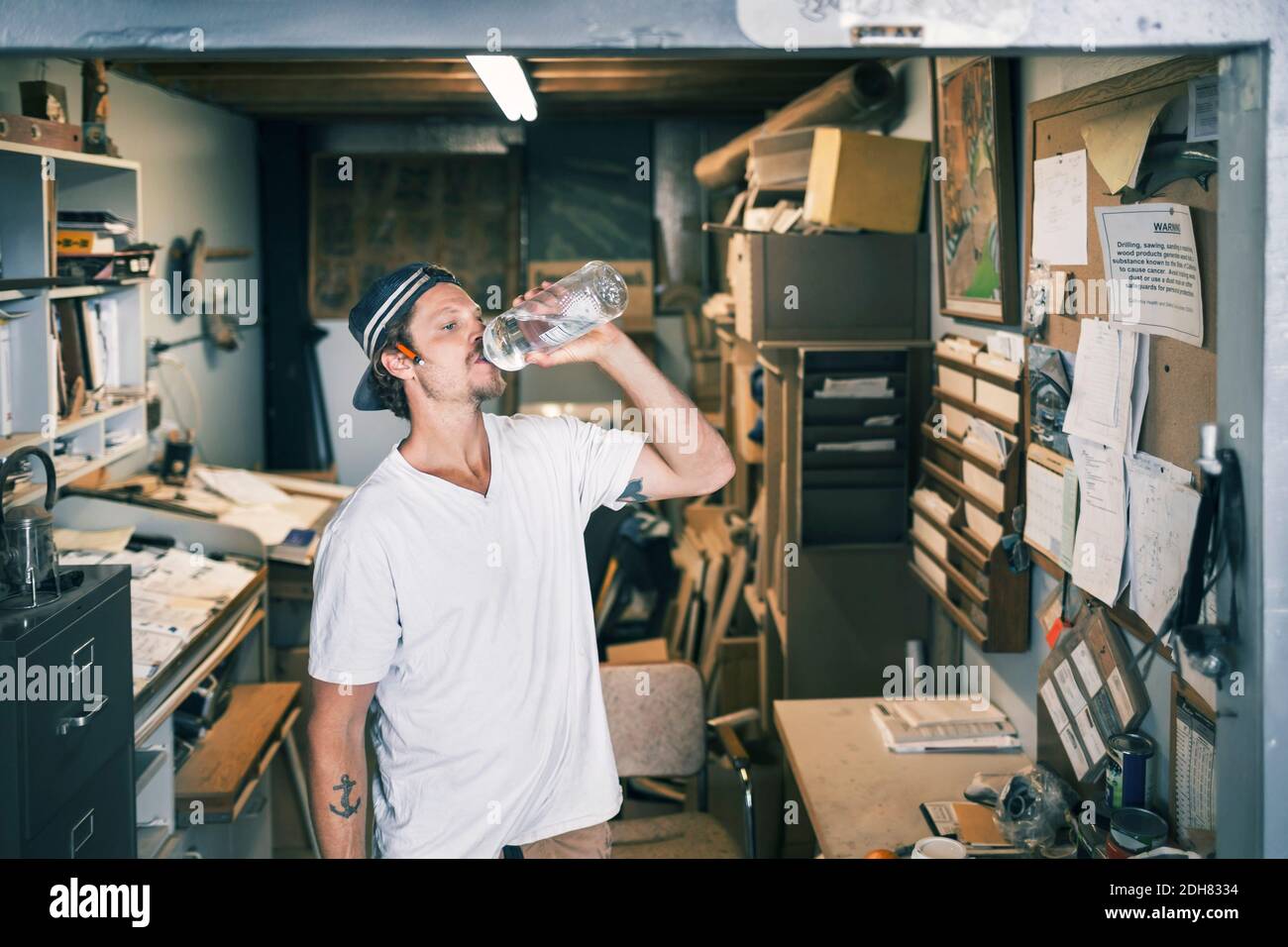 Carpenter drinking water in workshop Stock Photo - Alamy