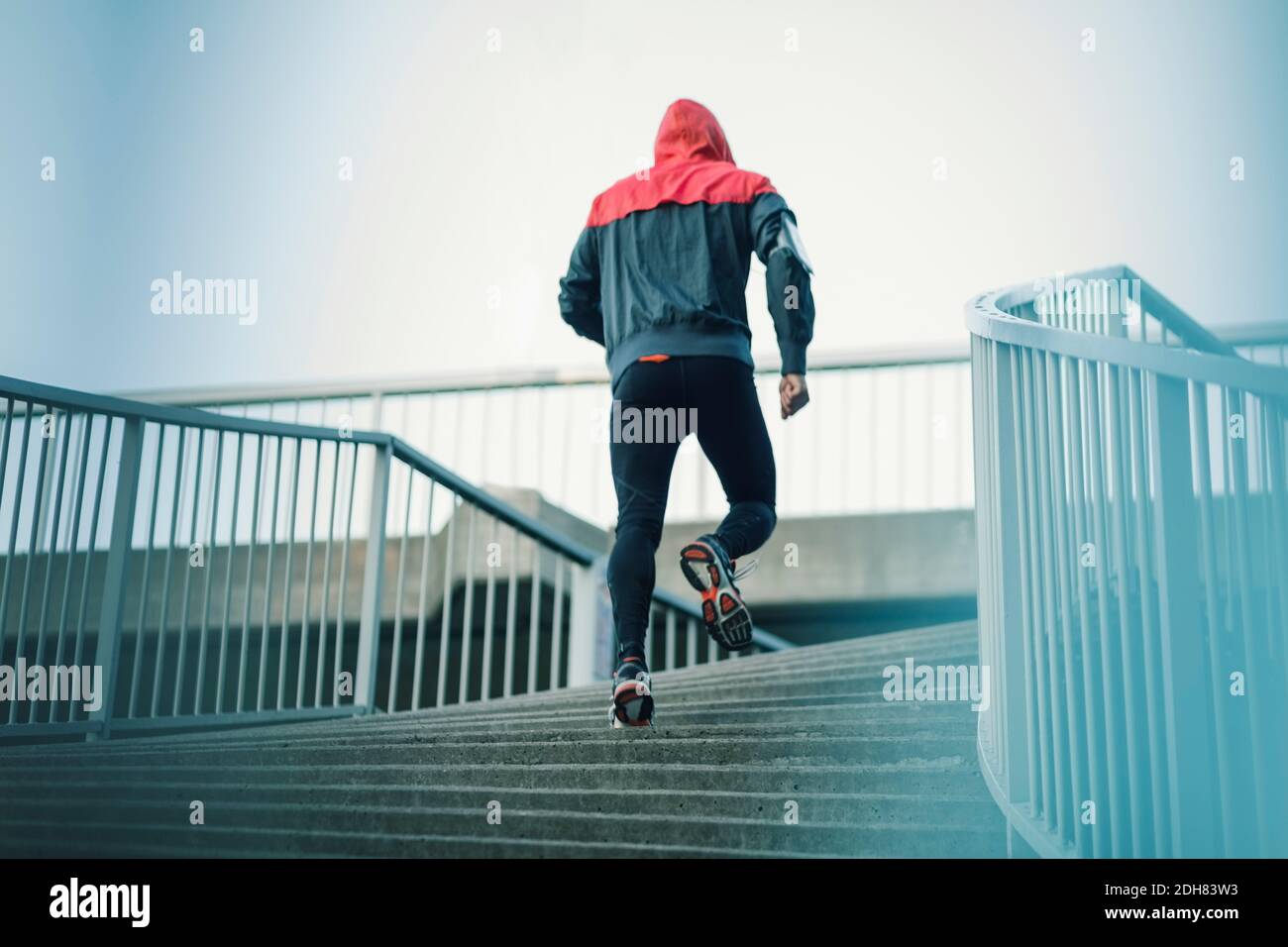 Rear view of man running on steps Stock Photo - Alamy