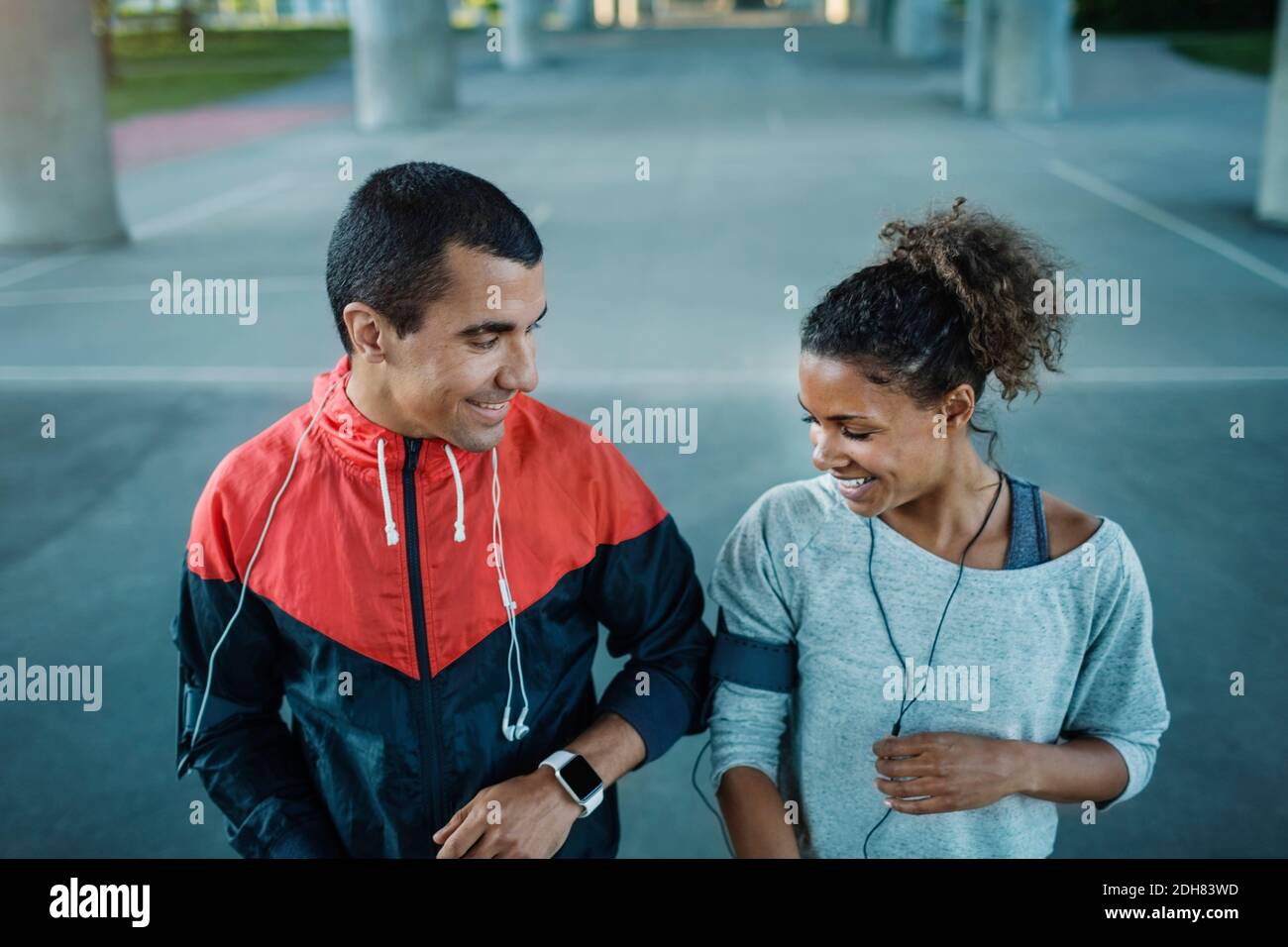 Friends touching arms while walking on street Stock Photo - Alamy