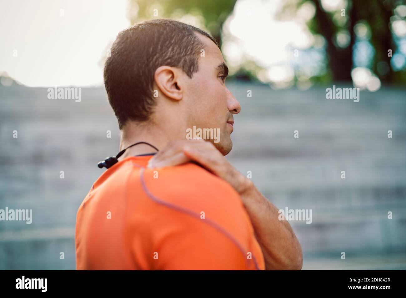 Man touching shoulder while standing on steps Stock Photo - Alamy