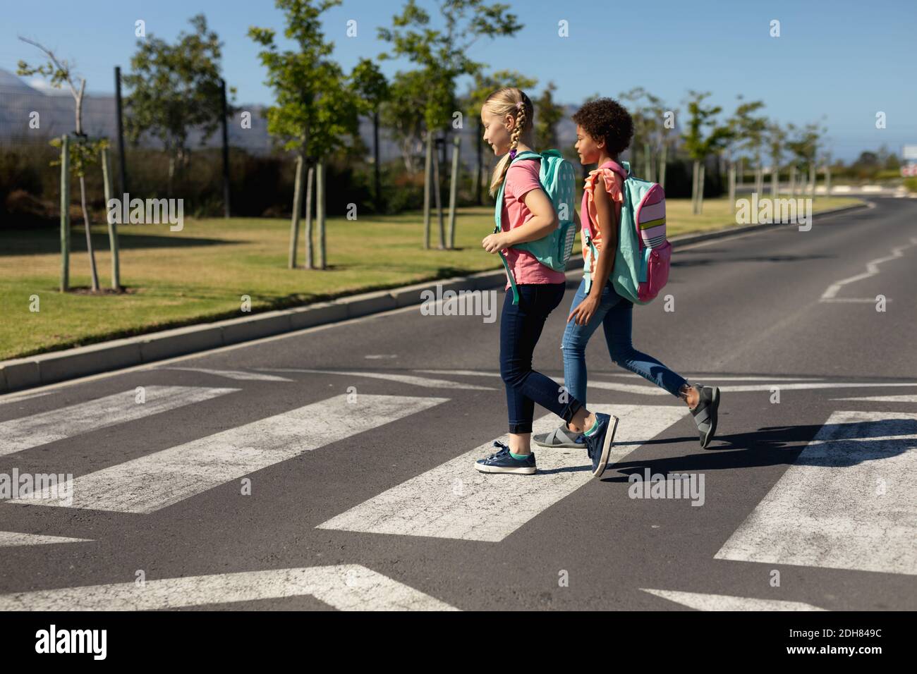 Schoolgirls crossing the road on a pedestrian crossing Stock Photo - Alamy