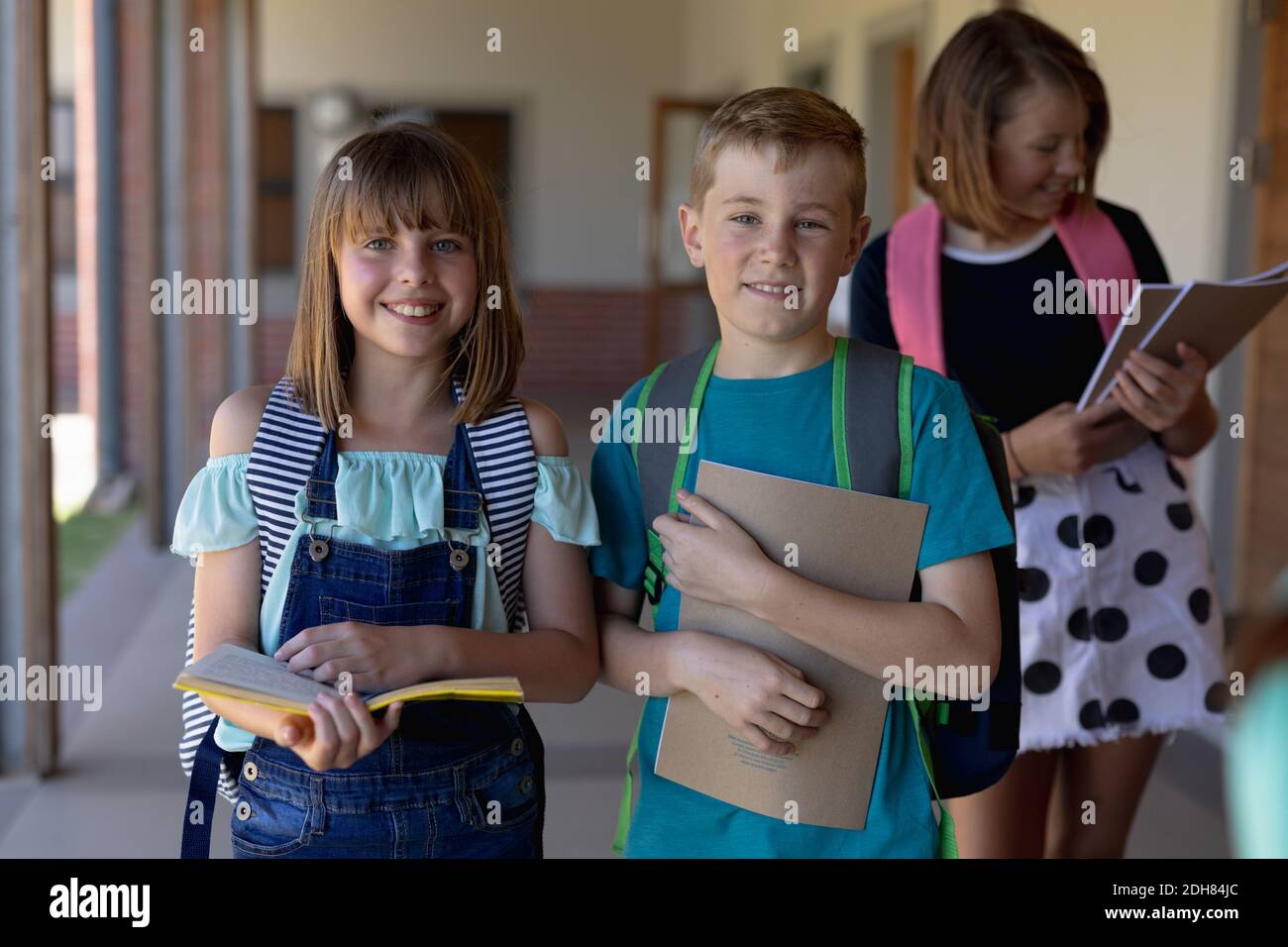 Schoolchildren standing in an outdoor corridor at elementary school ...