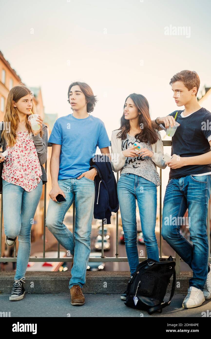 Teenagers leaning on railing hi-res stock photography and images - Alamy