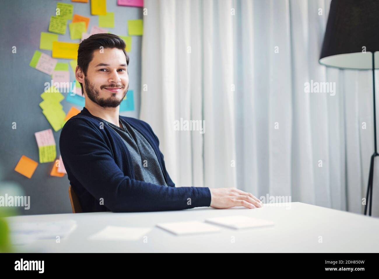 Portrait businessman sitting office desk hi-res stock photography and ...