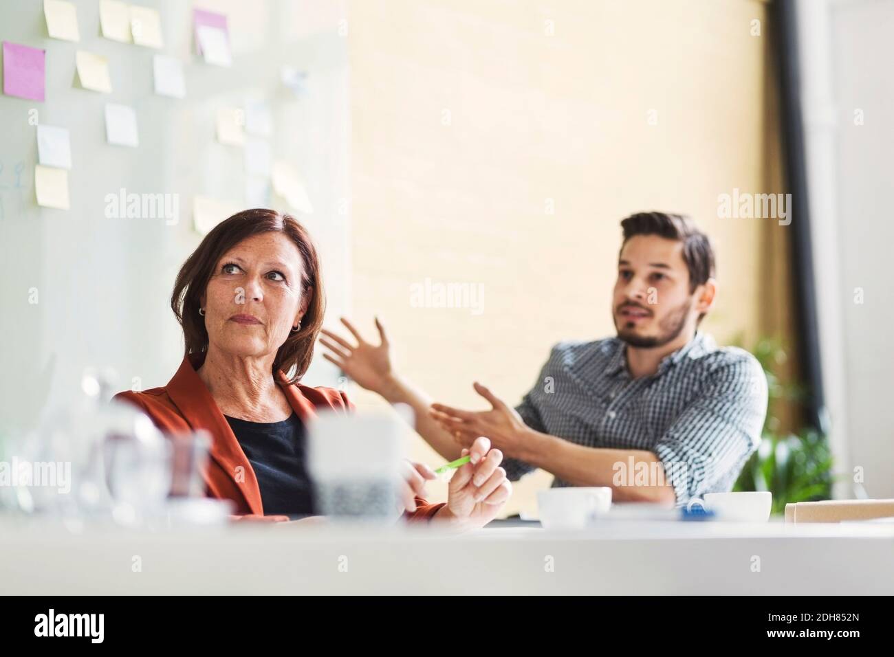 Businessman sharing ideas during meeting in conference room Stock Photo ...