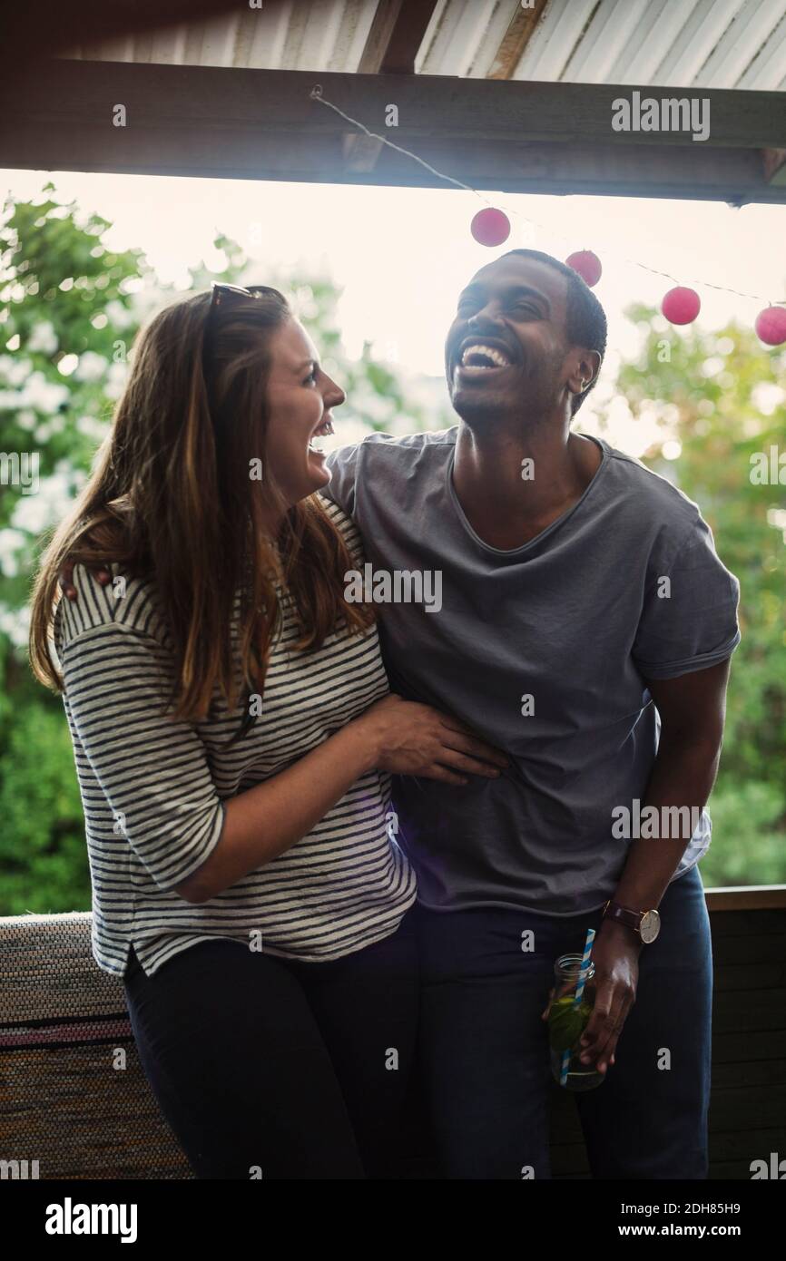 Happy couple enjoying in log cabin during party Stock Photo - Alamy